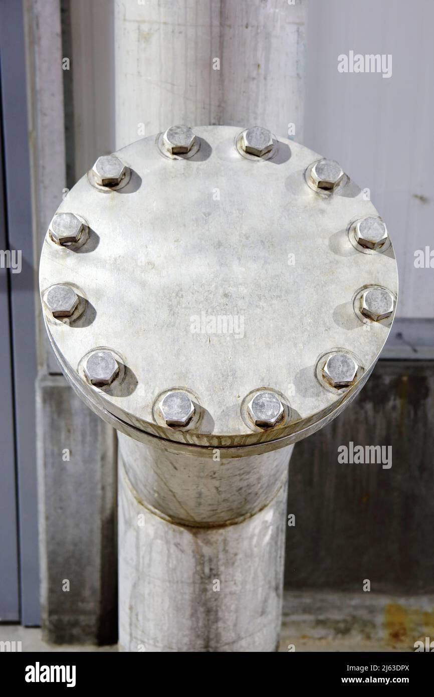 A cover plate in an industrial piping application, with 12 bolts evenly ...