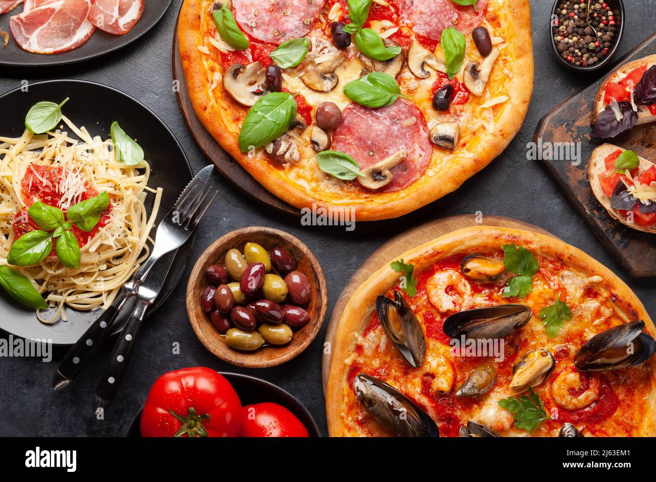 Italian cuisine. Pasta, pizza, olives and antipasto toasts. Flat lay ...