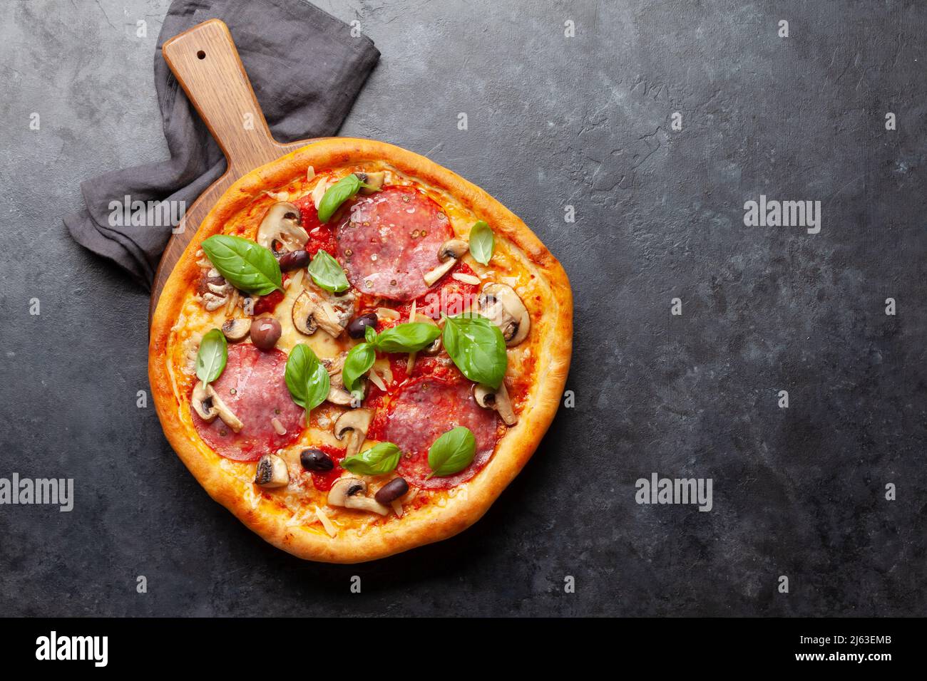 Italian cuisine. Pepperoni pizza. Flat lay on stone table with copy ...