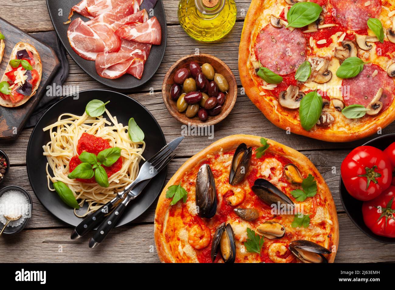 Italian cuisine. Pasta, pizza, olives and antipasto toasts. Flat lay ...