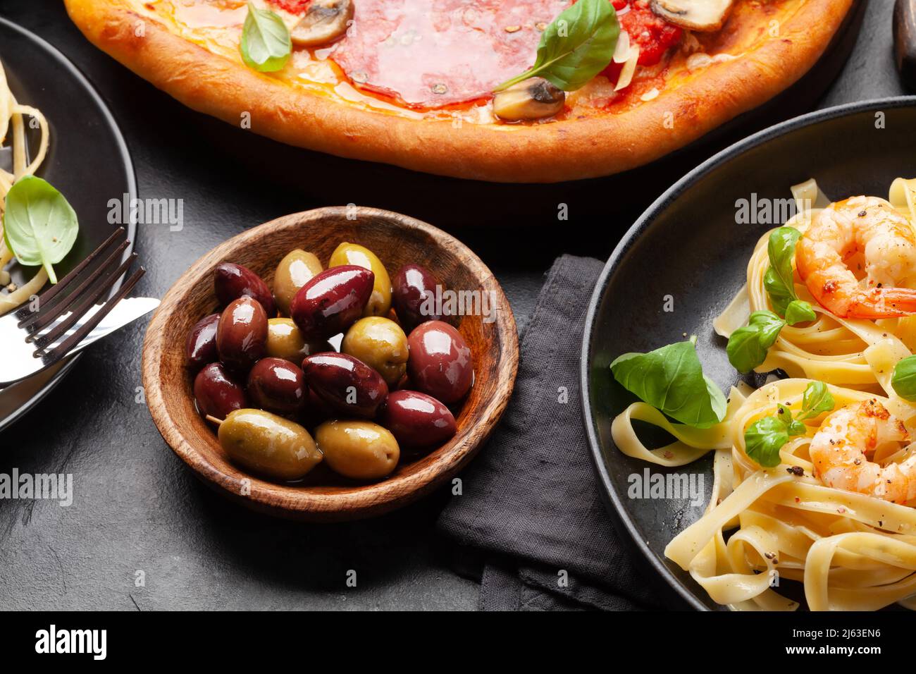 Italian cuisine. Pasta, pizza, olives and antipasto Stock Photo - Alamy