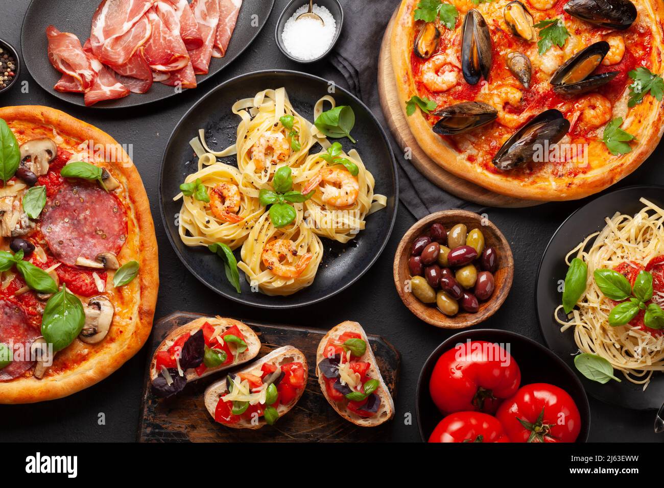 Italian cuisine. Pasta, pizza, olives and antipasto toasts. Flat lay ...