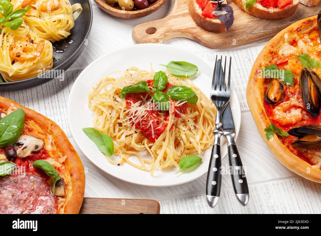 Italian cuisine. Pasta, pizza, olives and antipasto toasts Stock Photo - Alamy
