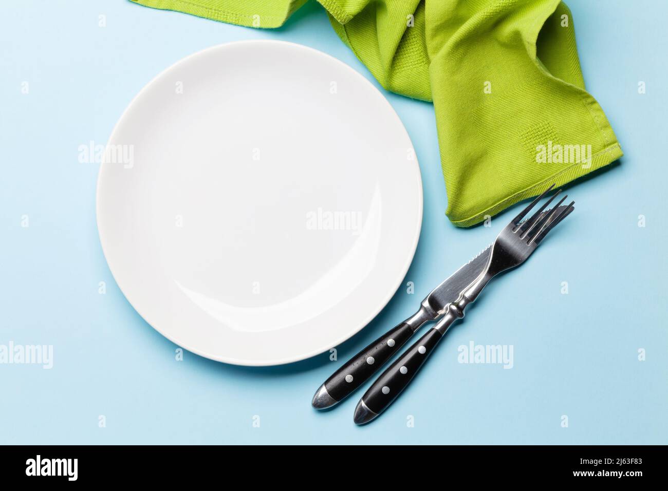 Empty plate and silverware. Top view flat lay with copy space. Template ...