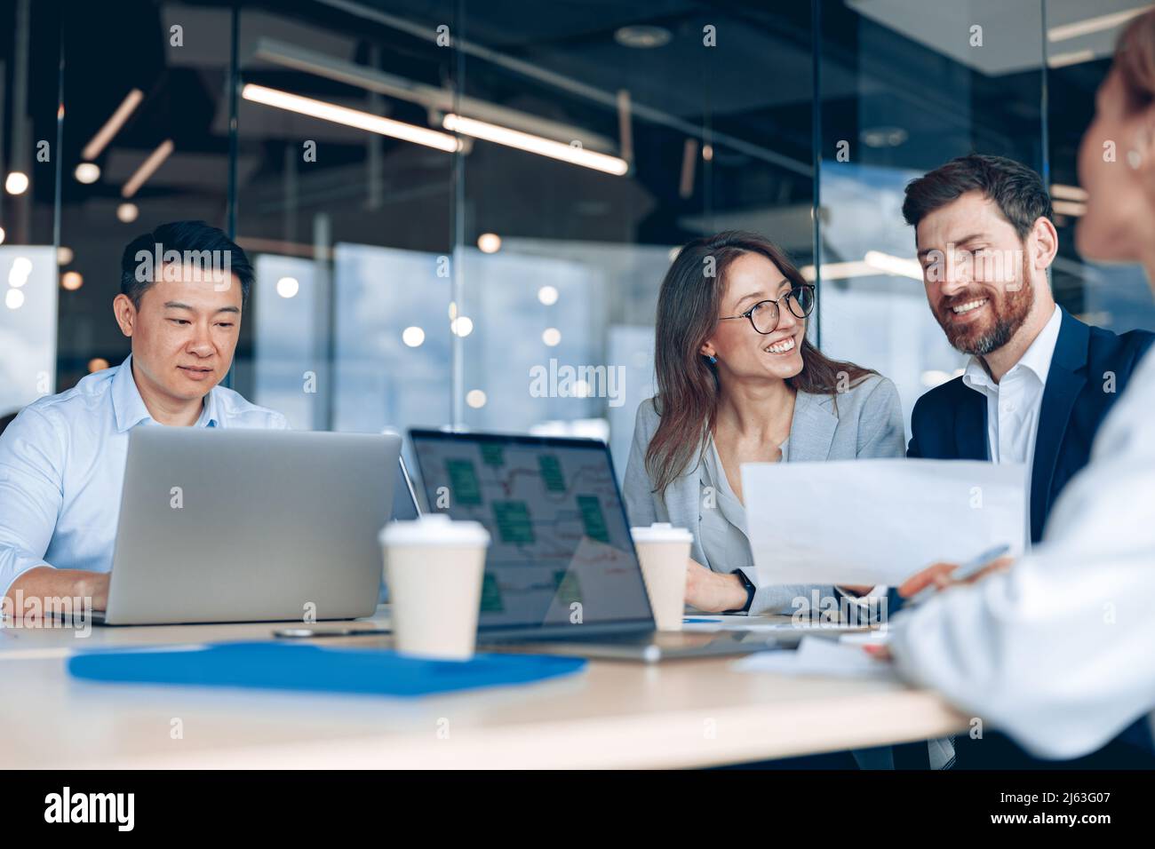 Positive business team working on new project in modern office Stock ...