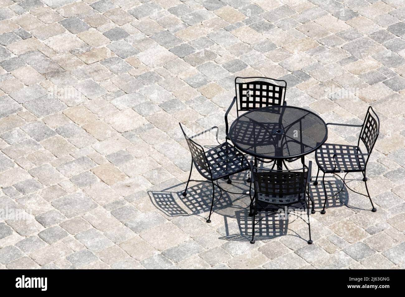 An overhead view of a comfortable patio with a wrought iron table and ...