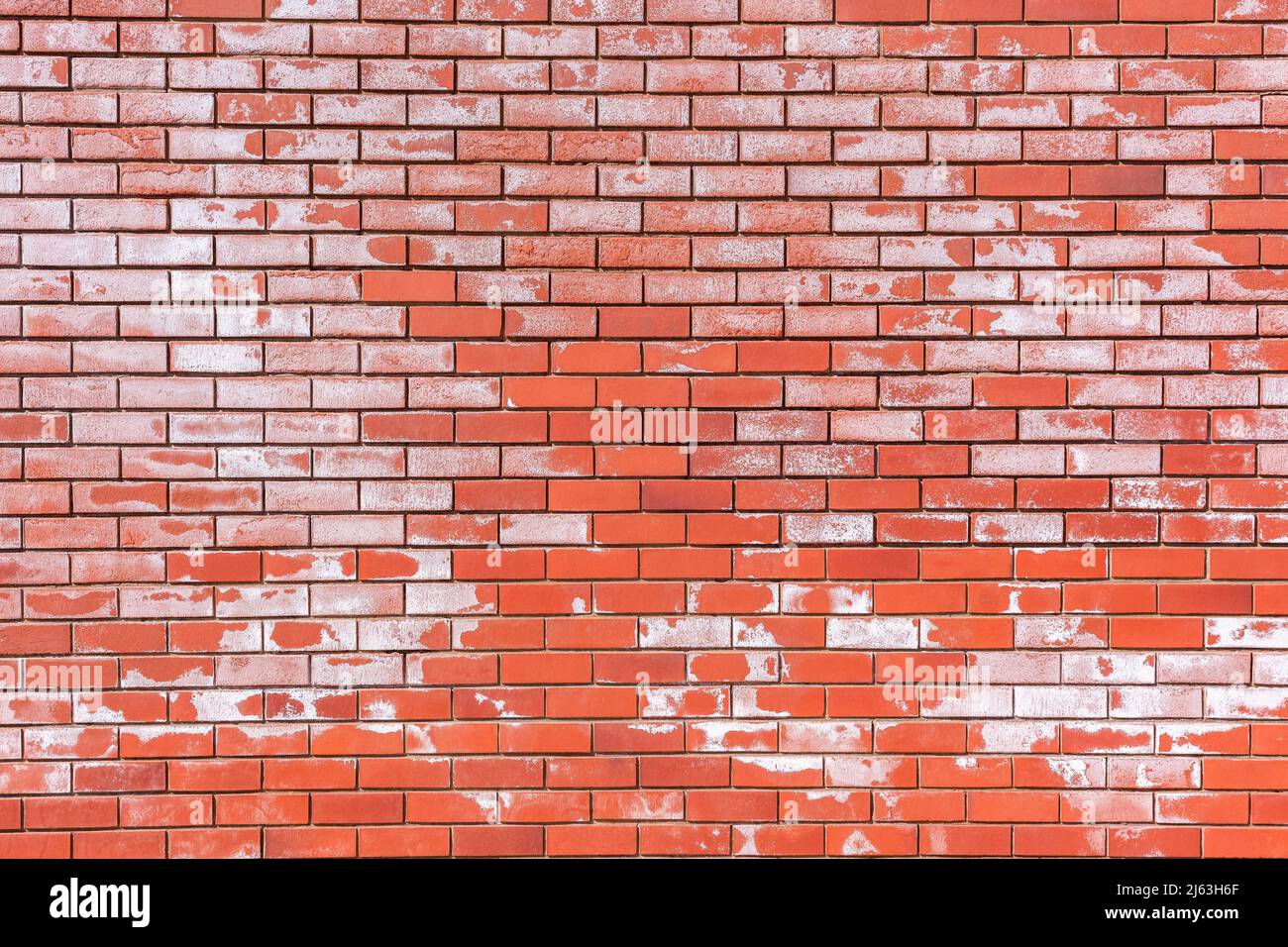 Red brick wall close-up with white salt patches for abstract detail ...