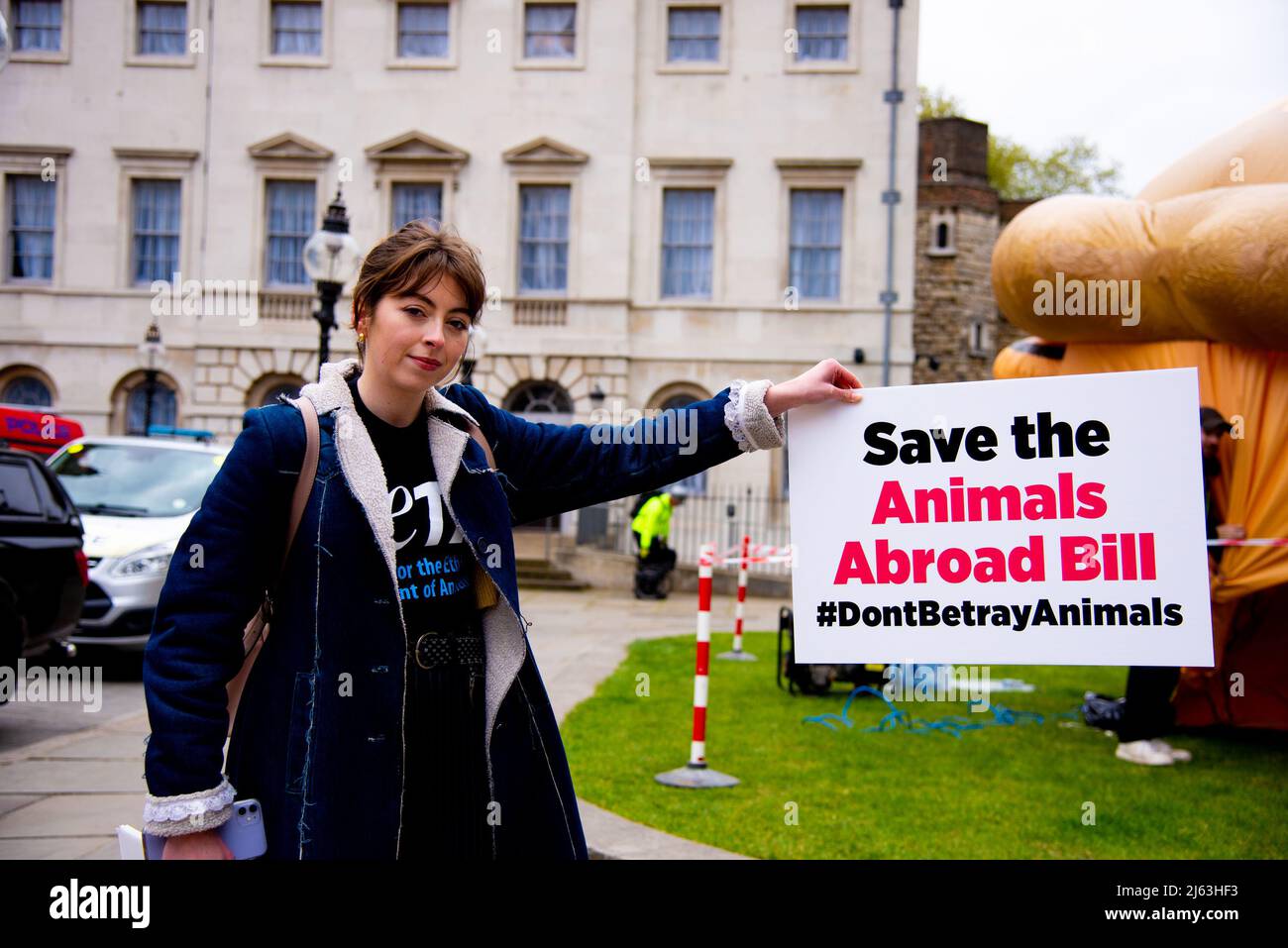 London, UK. 27th Apr, 2022. A protestor holds a placard that says ...