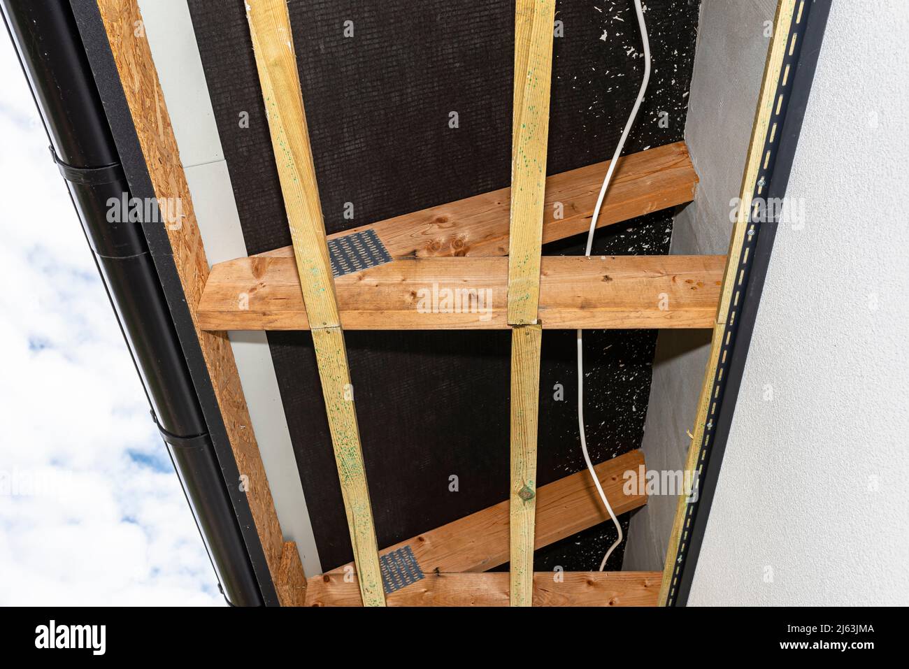 Scaffolding with three rows of wooden battens for attaching the PVC ...