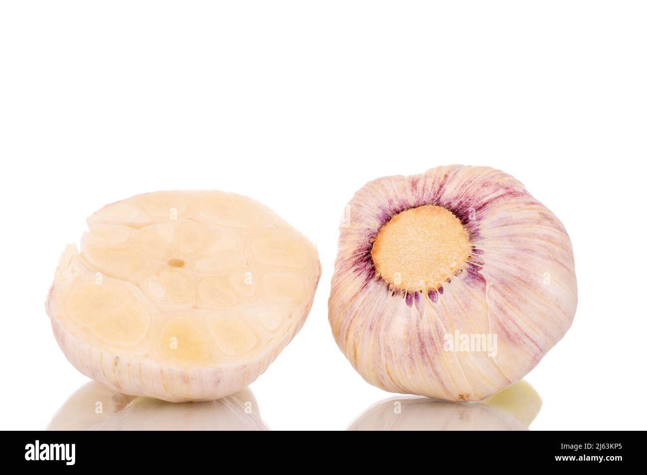 One whole head and one half of early garlic, close-up, isolated on a ...