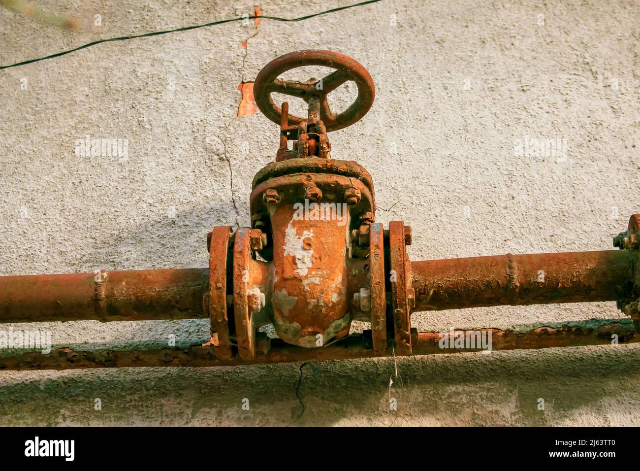Rusty old gas tap on the background of the wall of the house Stock ...