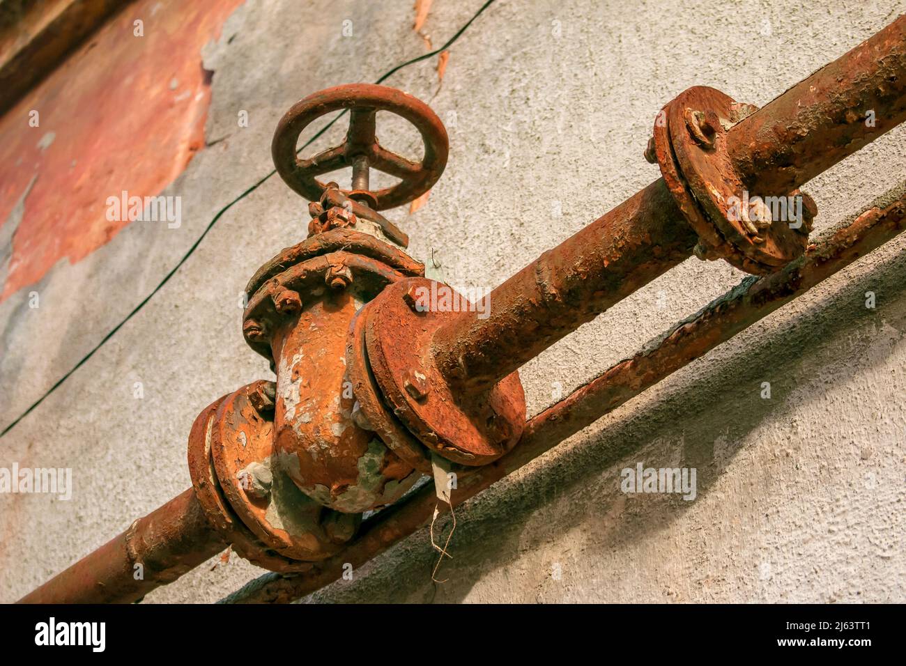 Rusty old gas tap on the background of the wall of the house Stock ...