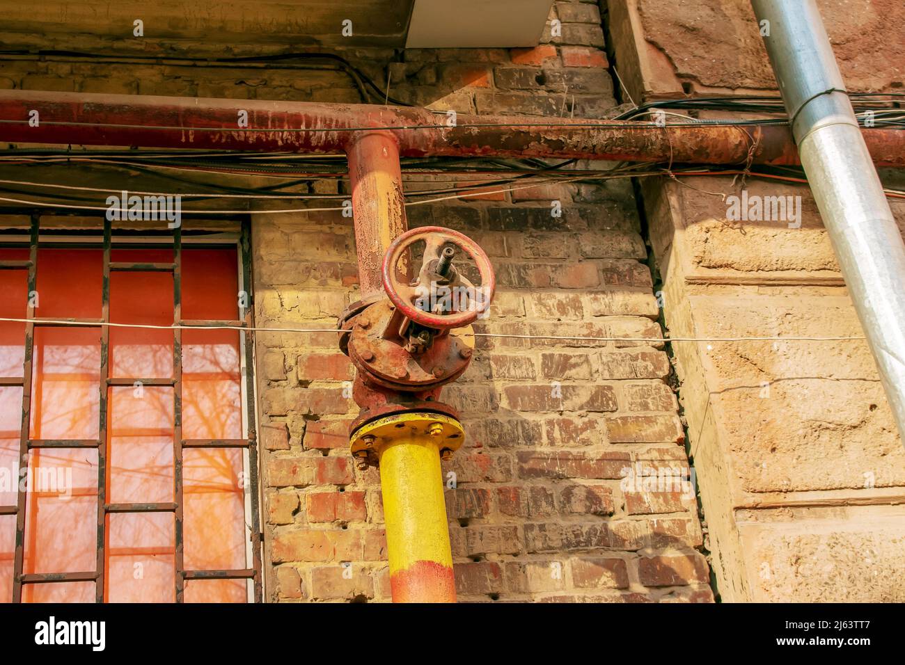 Rusty old gas tap on the background of the wall of the house Stock ...