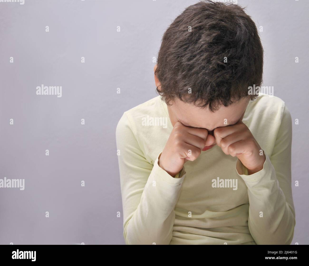 little boy praying to God with hands together with people stock photo ...