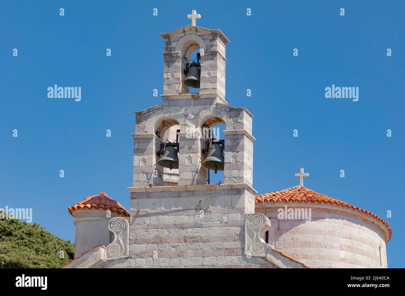 Church bell tower with cross on the top and three outdoor large metal ...
