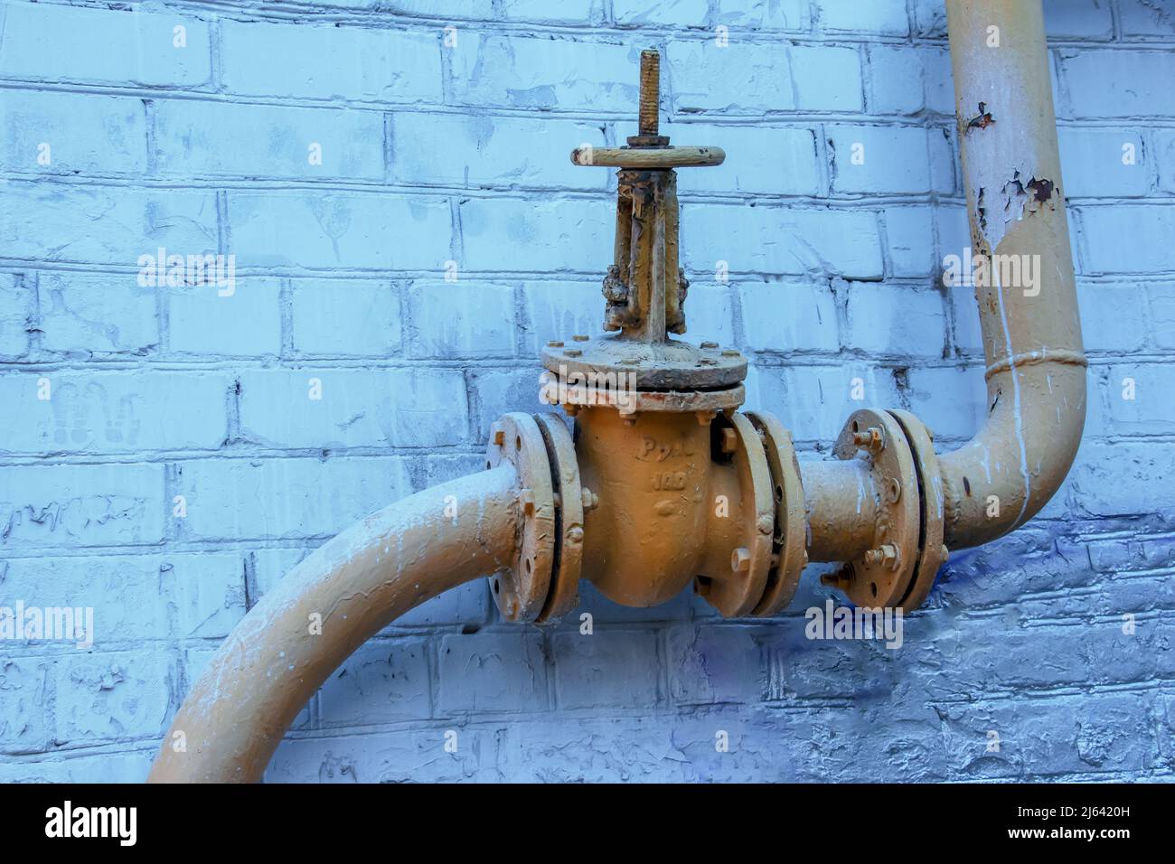 Rusty old gas tap on the background of the wall of the house Stock ...