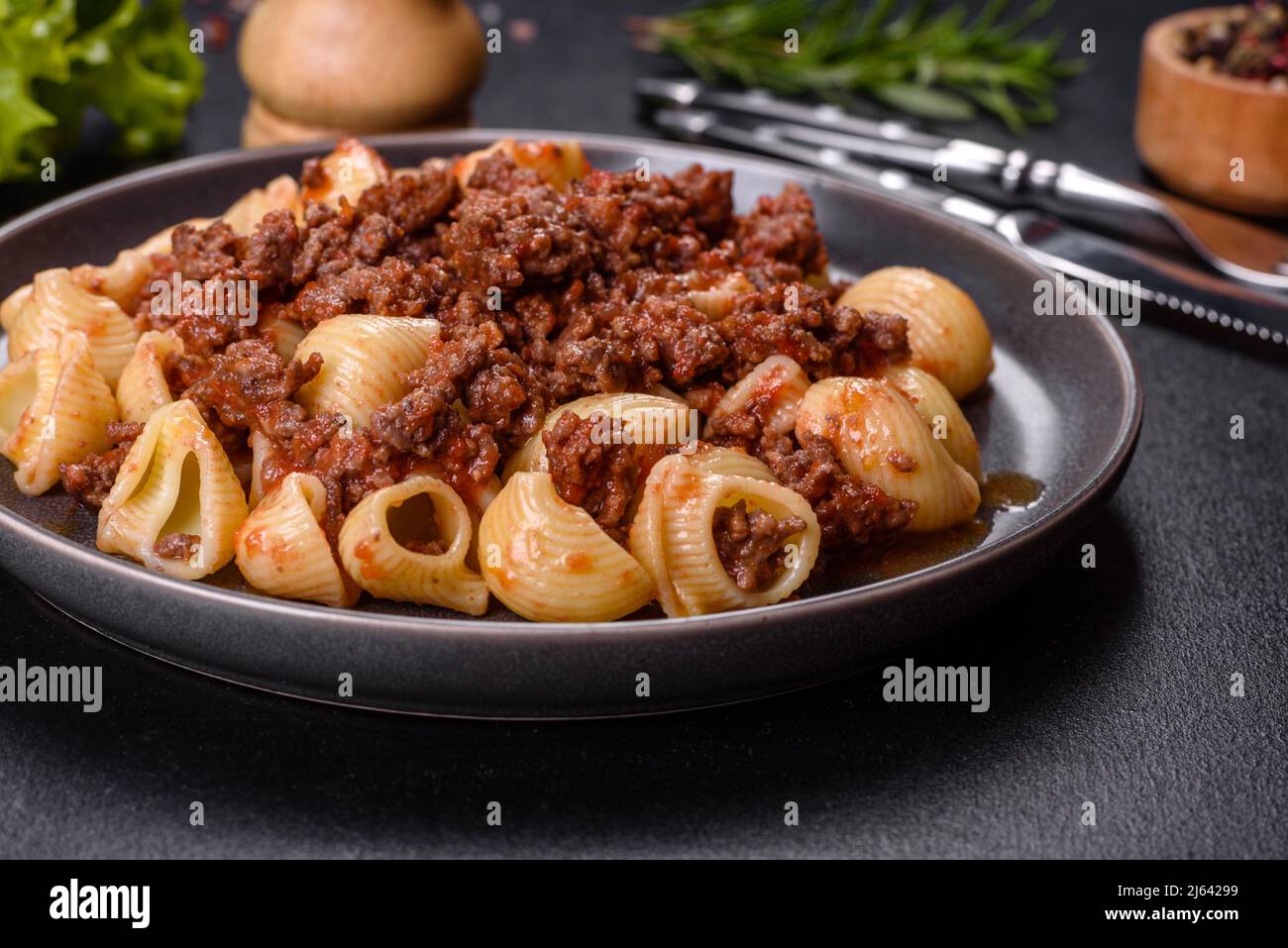 Pasta pappardelle with beef ragout sauce in black bowl. Dark background ...