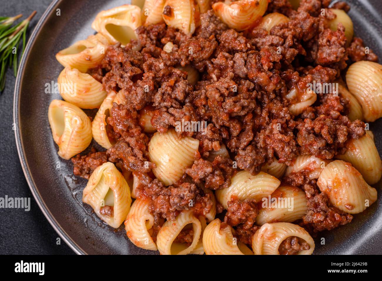 Pasta pappardelle with beef ragout sauce in black bowl. Dark background ...