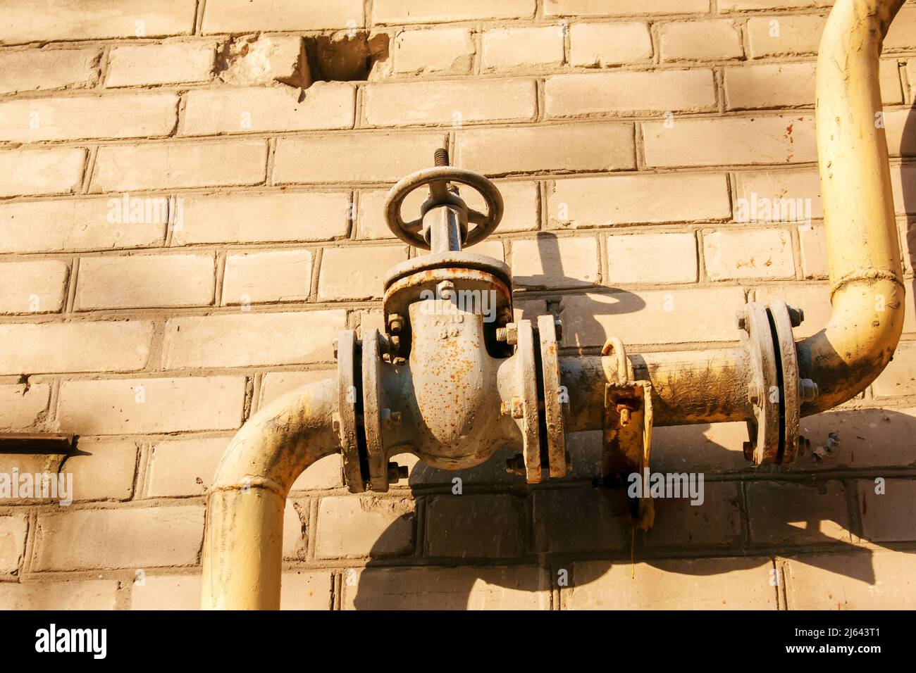 Rusty old gas tap on the background of the wall of the house Stock ...