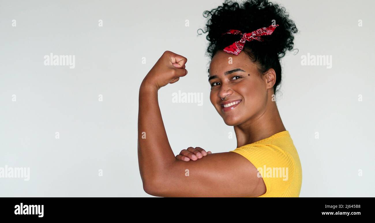 Black woman we can do it muscle pose Stock Photo - Alamy