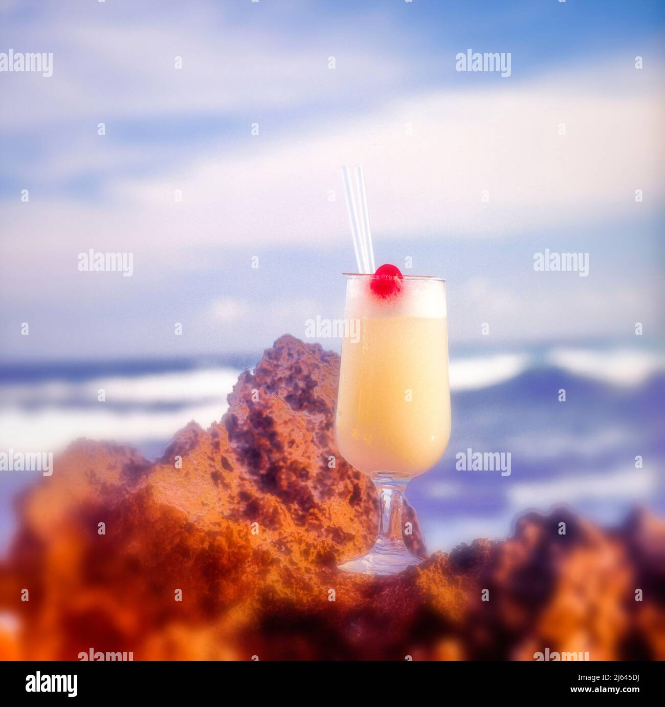 Drinks still-life of Piña Colada with cherry garnish on the rocks with ...