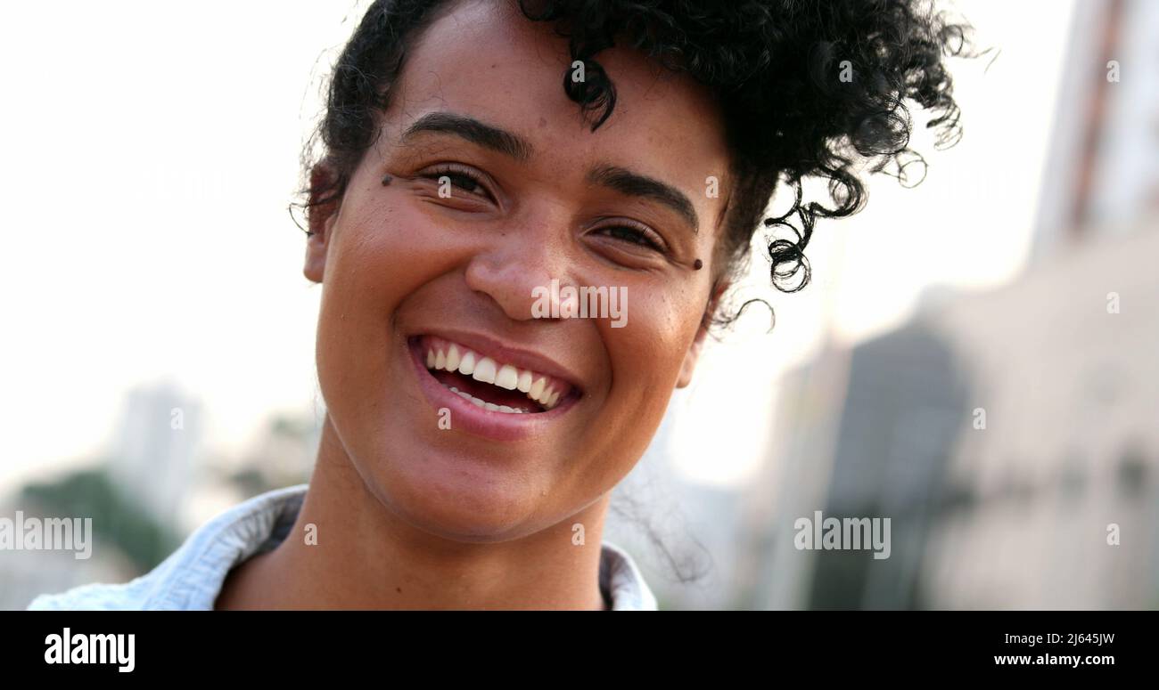 Happy young black woman spontaneous smile and laugh. Person with ...
