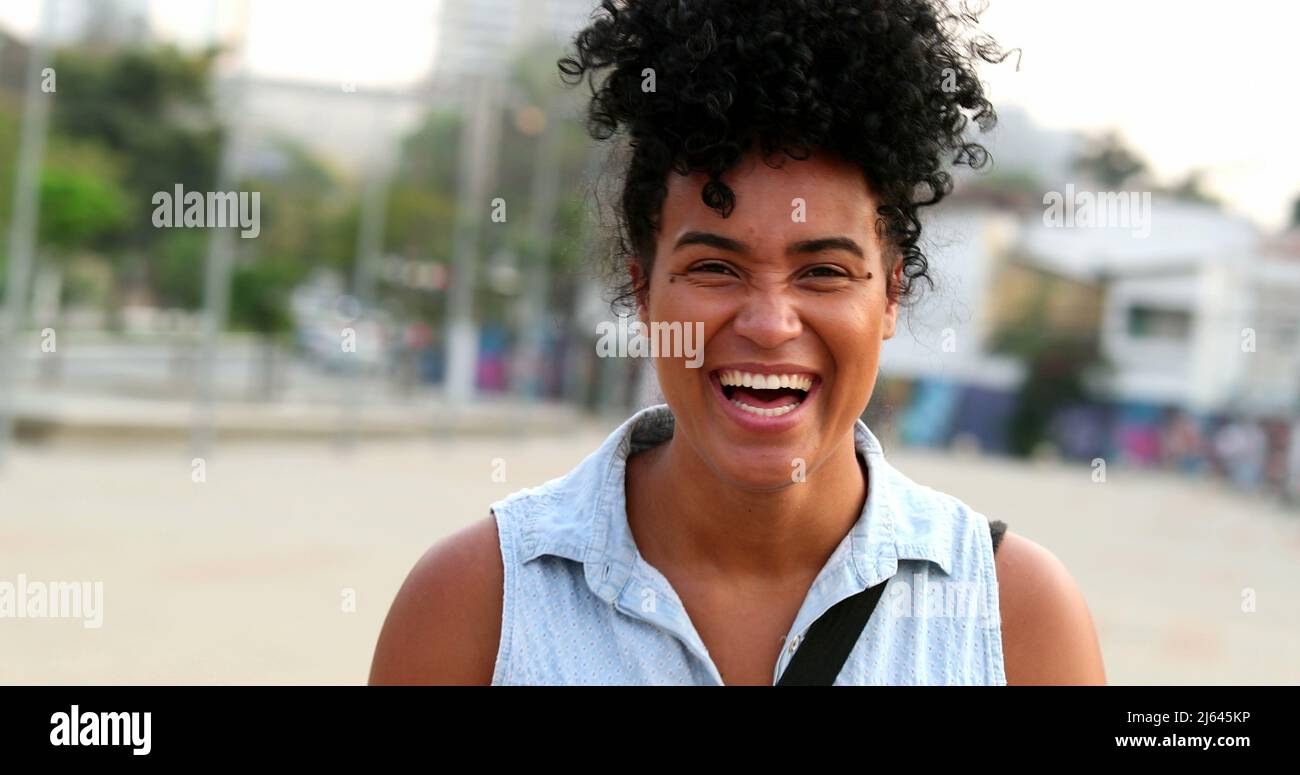 Happy young black woman spontaneous smile and laugh. Person with ...