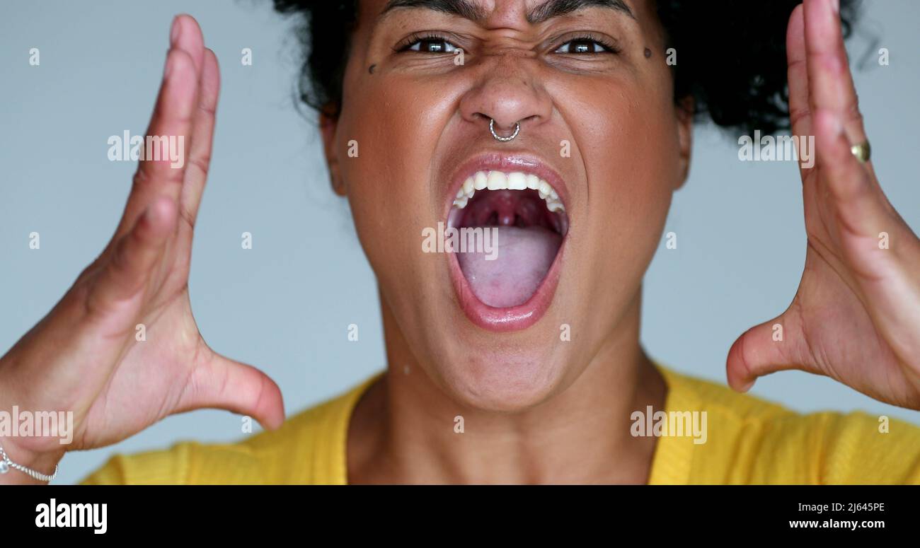 Millennial black woman shouting at camera Stock Photo - Alamy