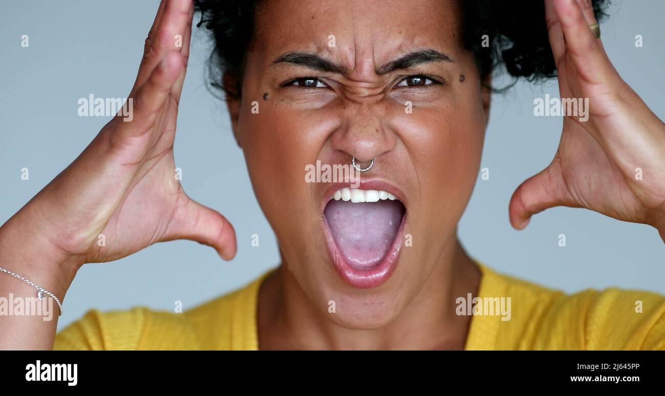 Millennial black woman shouting at camera Stock Photo - Alamy