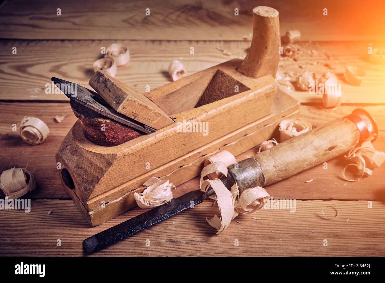 Carpenter tool chisel and wooden plane on workbench Stock Photo - Alamy