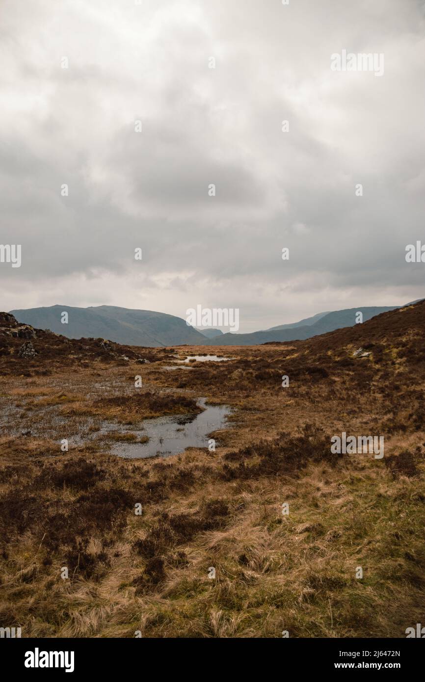 Mirror-like Highland lake in a rocky landscape, along the Haystacks ...