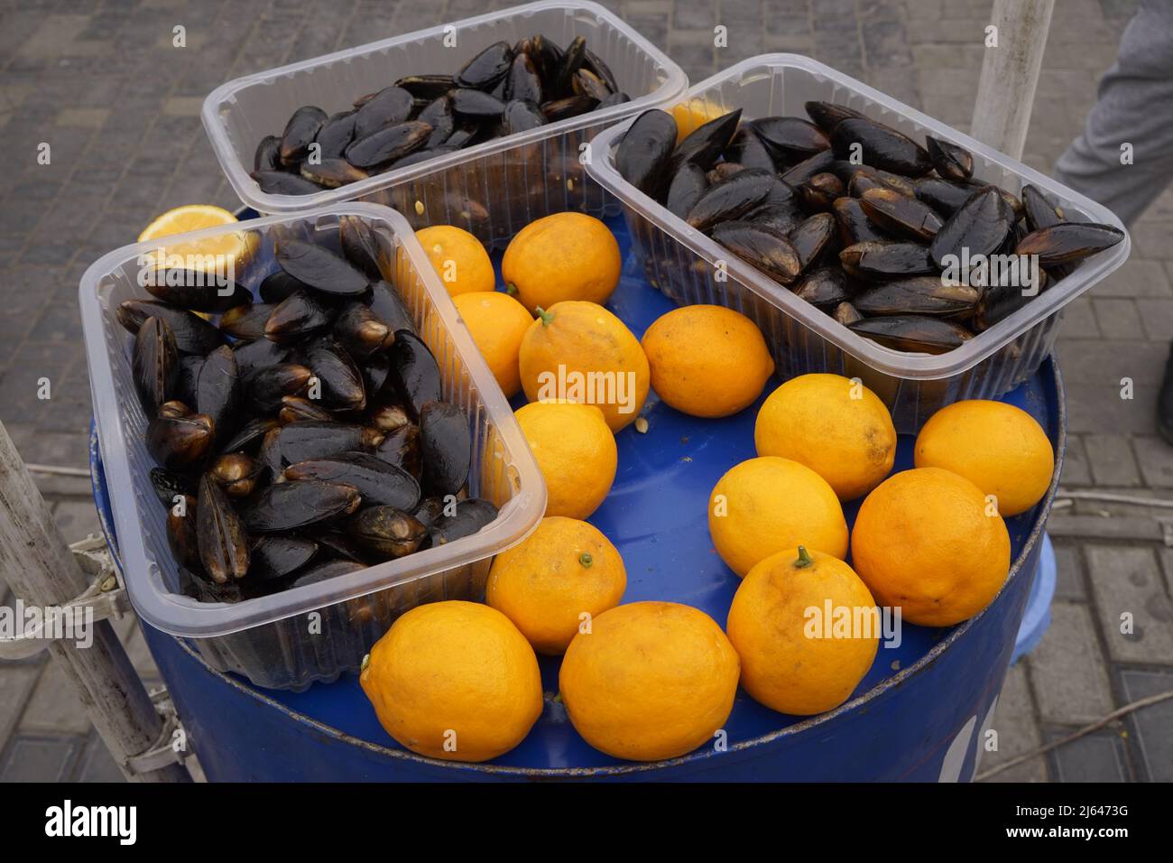 Mussels in the shell with lemon on blue iron background Stock Photo - Alamy