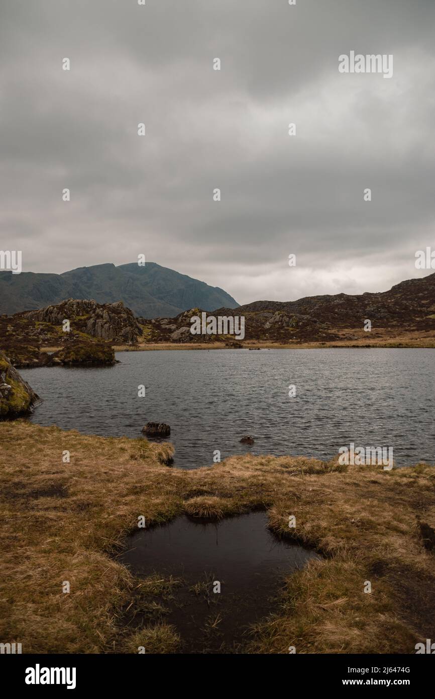 Mirror-like Highland lake in a rocky landscape, along the Haystacks ...