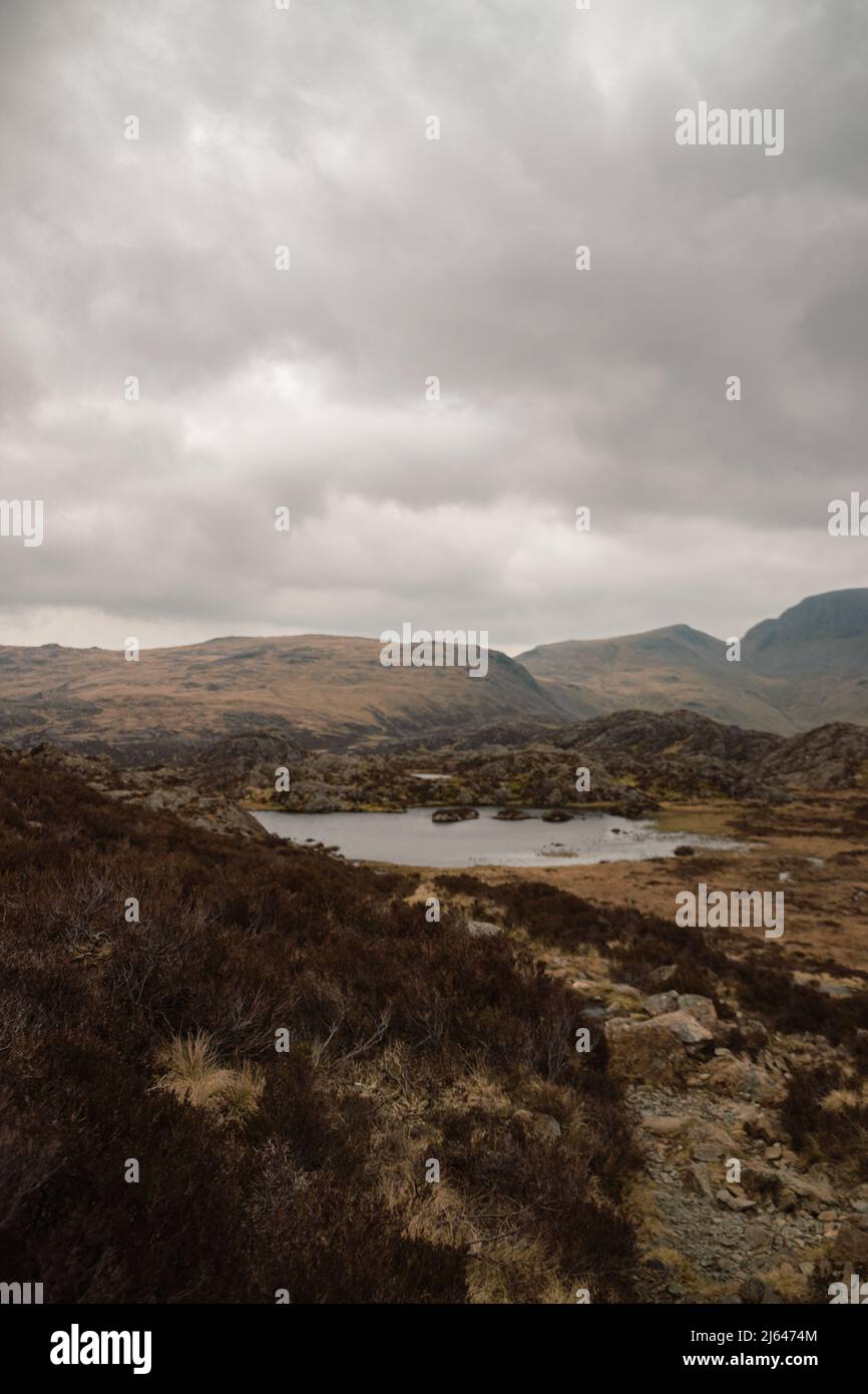 Mirror-like Highland lake in a rocky landscape, along the Haystacks ...