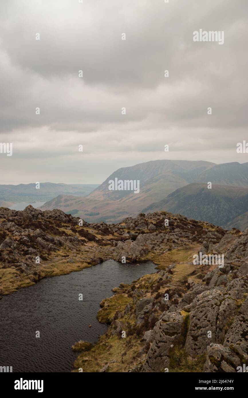 Mirror-like Highland lake in a rocky landscape, along the Haystacks ...