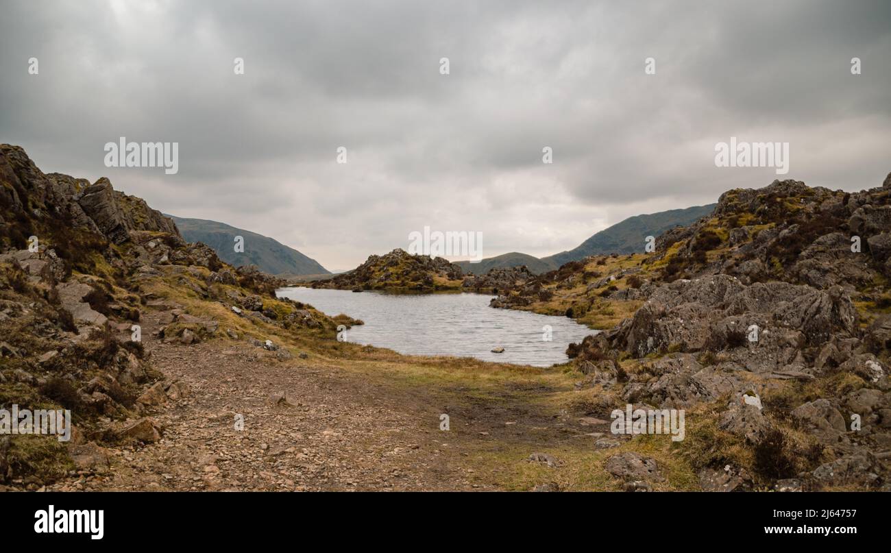 Mirror-like Highland lake in a rocky landscape, along the Haystacks ...