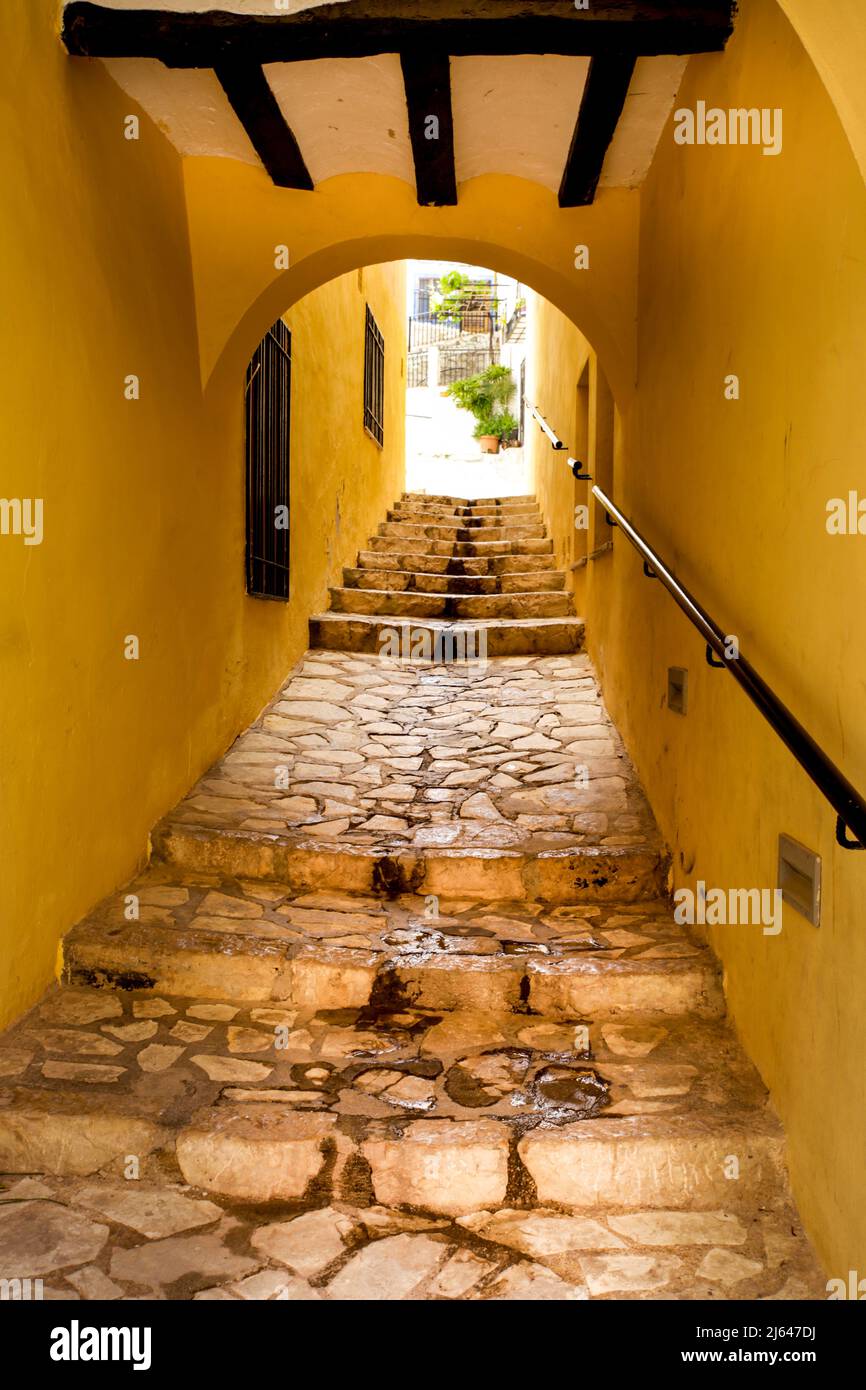 Narrow cobbled passage with stone stairs in Finestrat village, Alicante ...