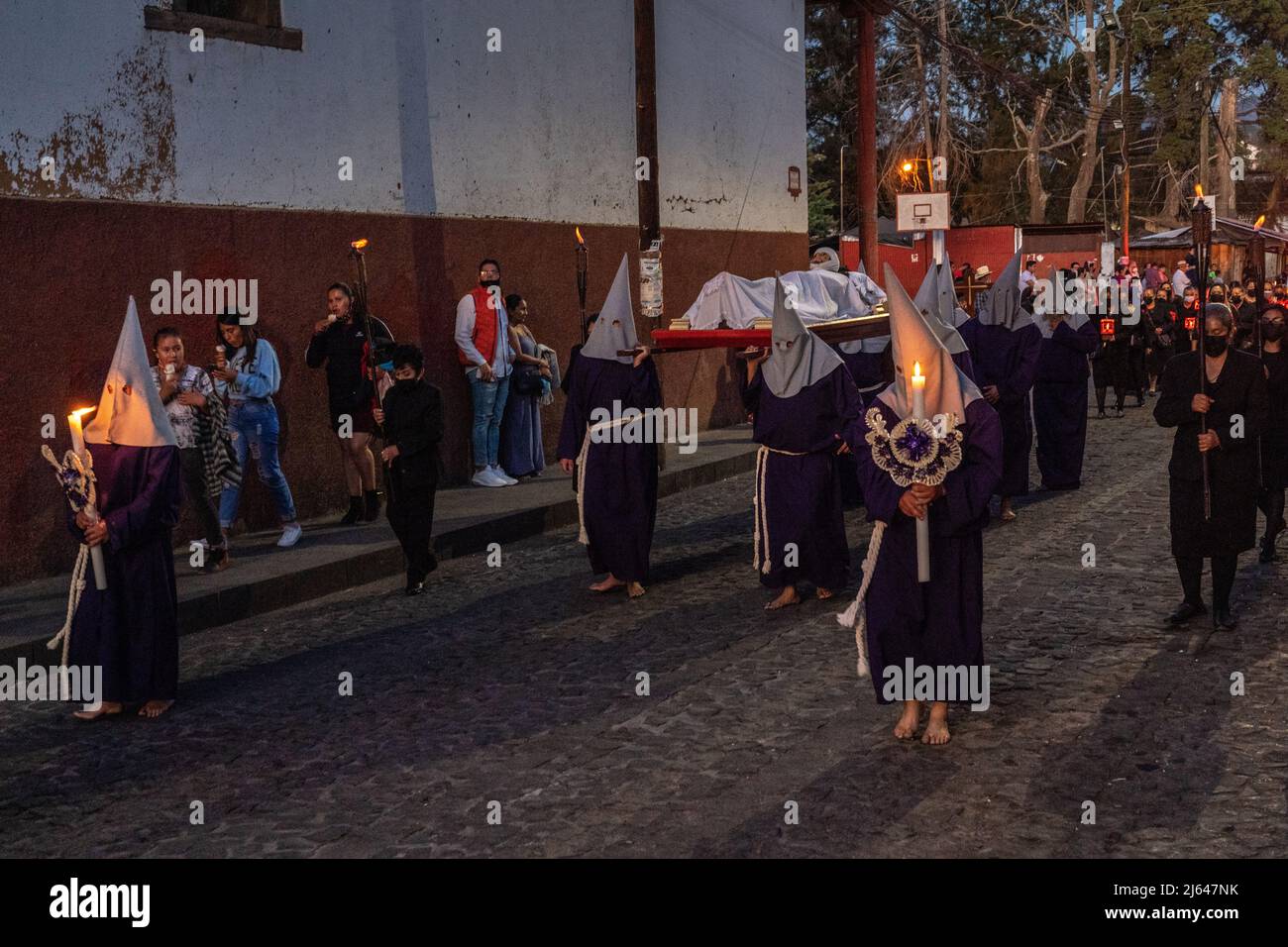 Roman Catholic hooded penitents wearing traditional capirotes, carry a ...