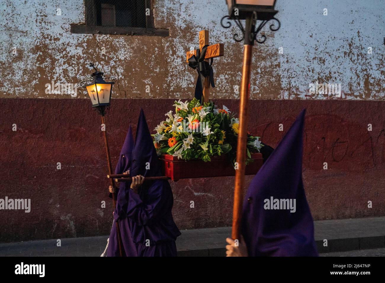 Roman Catholic hooded penitents wearing traditional capirotes, carry a ...