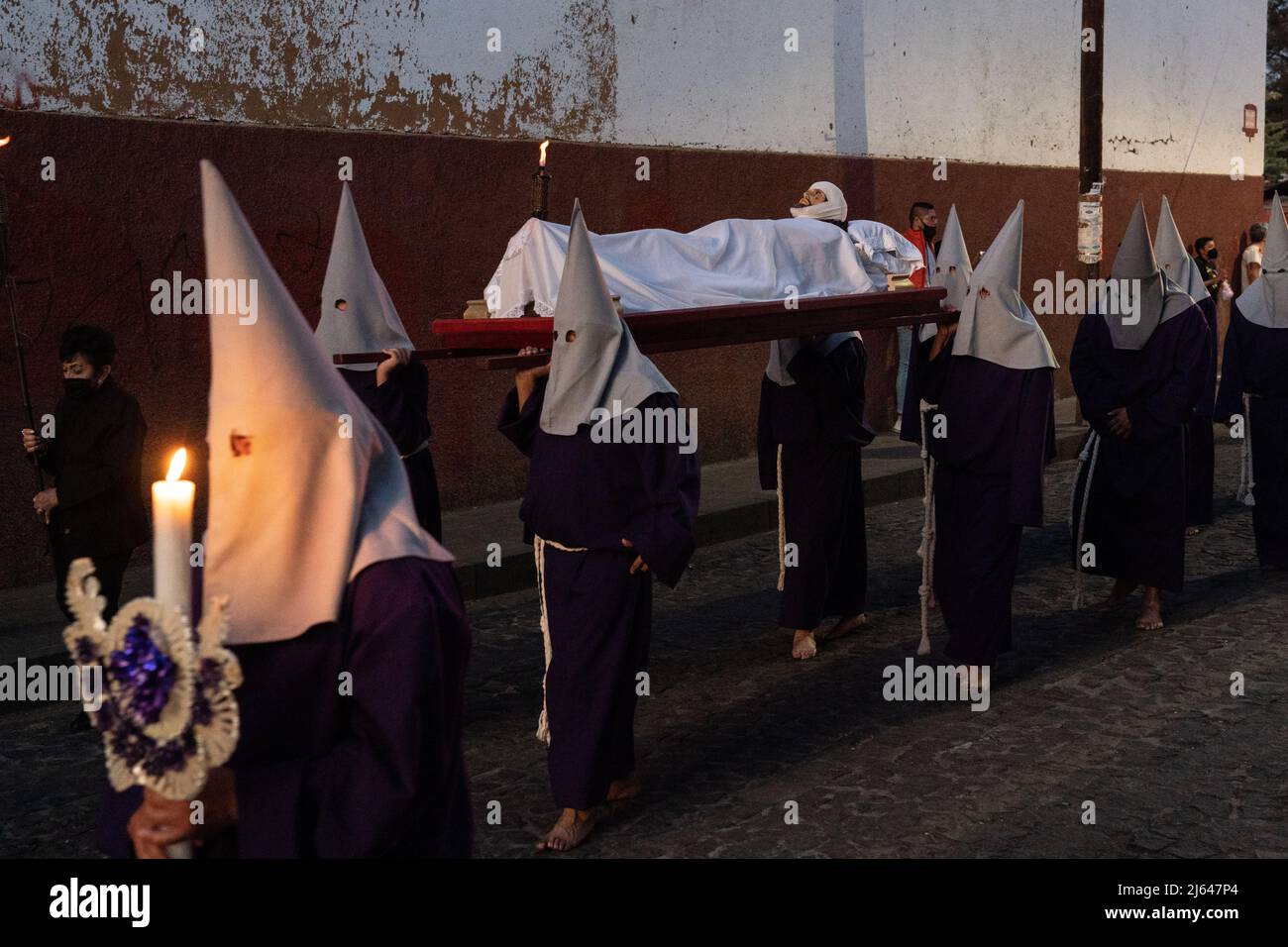 Roman Catholic hooded penitents wearing traditional capirotes, carry a ...