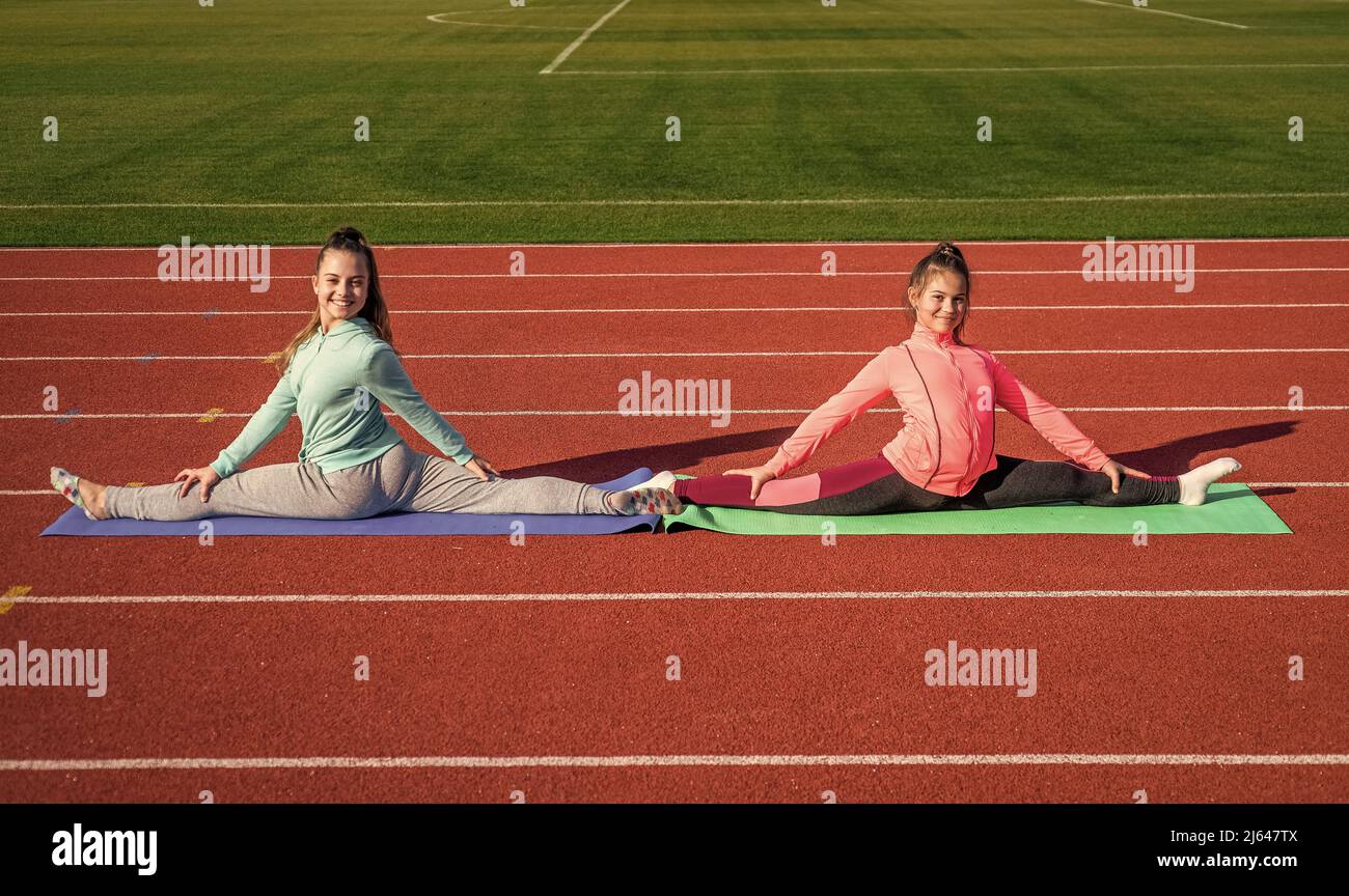 Grow in yoga. Flexible children do splits on stretch mat. Yoga and ...