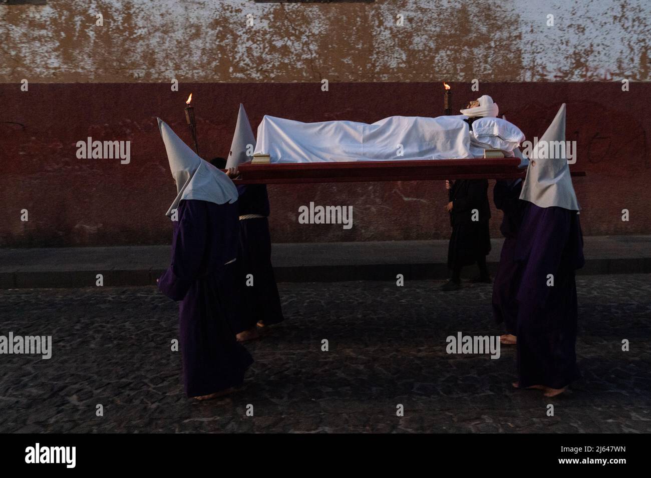 Roman Catholic hooded penitents wearing traditional capirotes, carry a ...