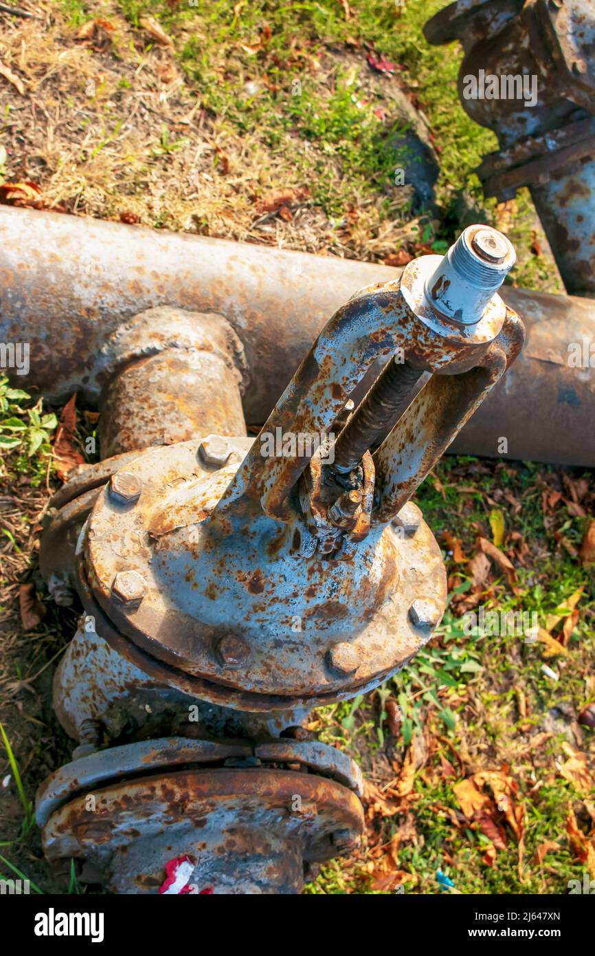Rusty old water faucet on the background and tubes of water supply ...