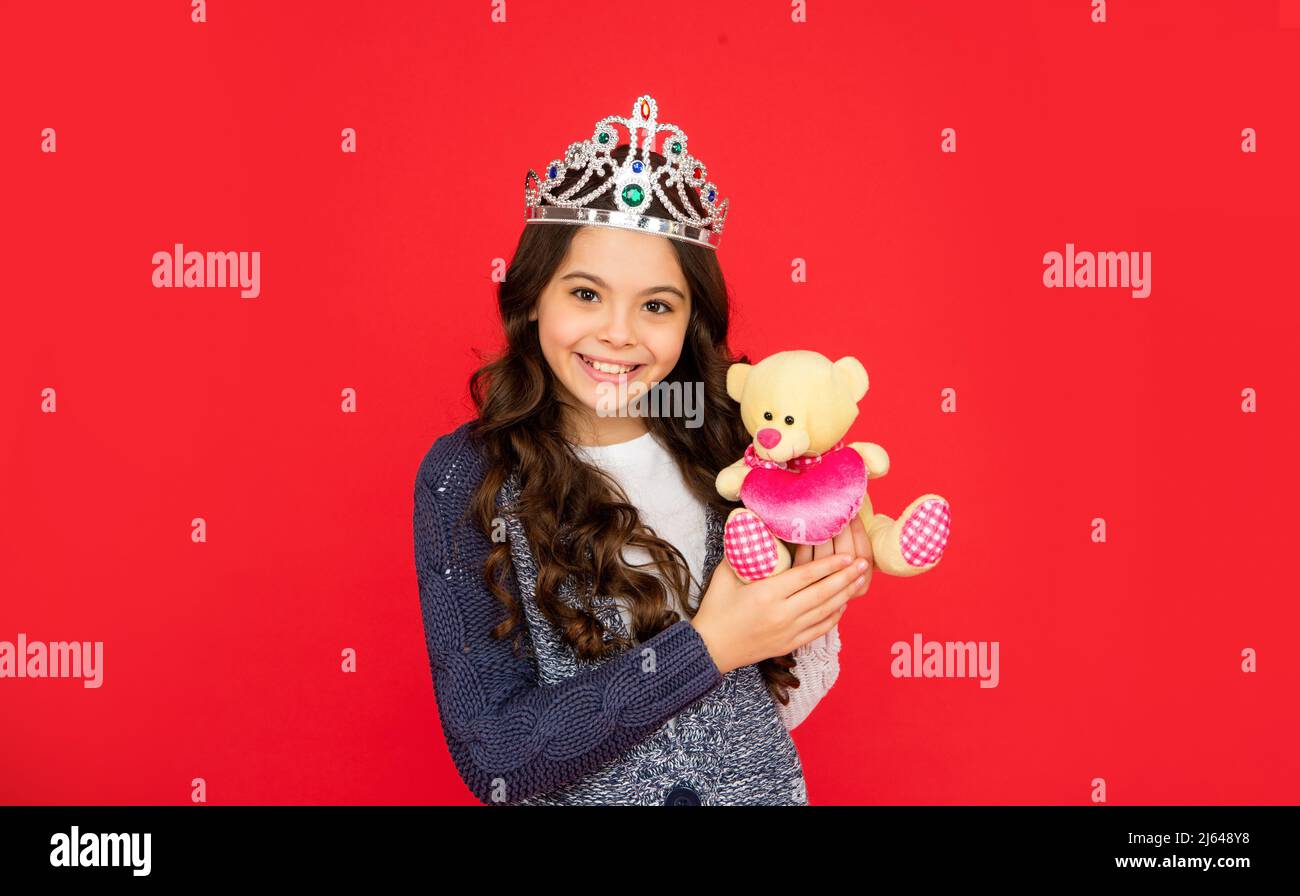 smiling child in queen crown. princess in tiara. kid hold bear toy ...