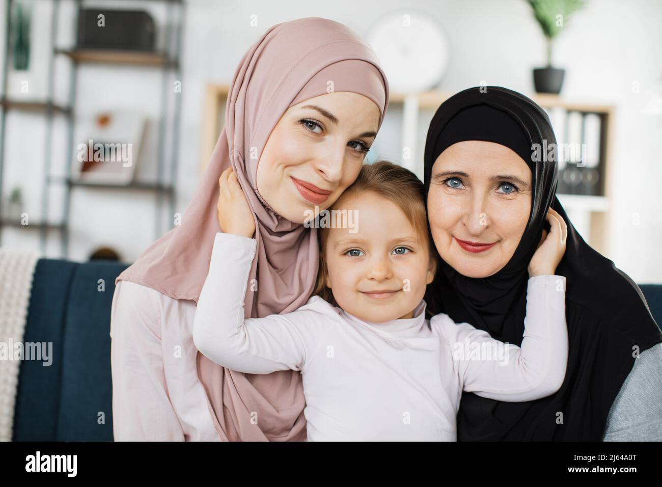 Head shot portrait happy three generations of islamic women in hijab ...
