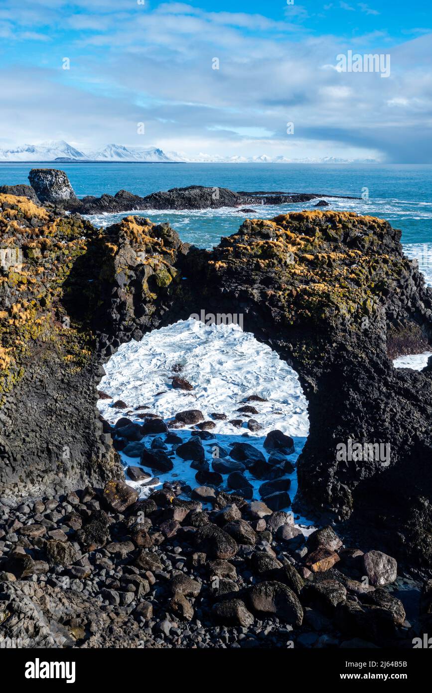 Photograph of the volcanic rock bridge at the Gatklettur Cliff walk ...