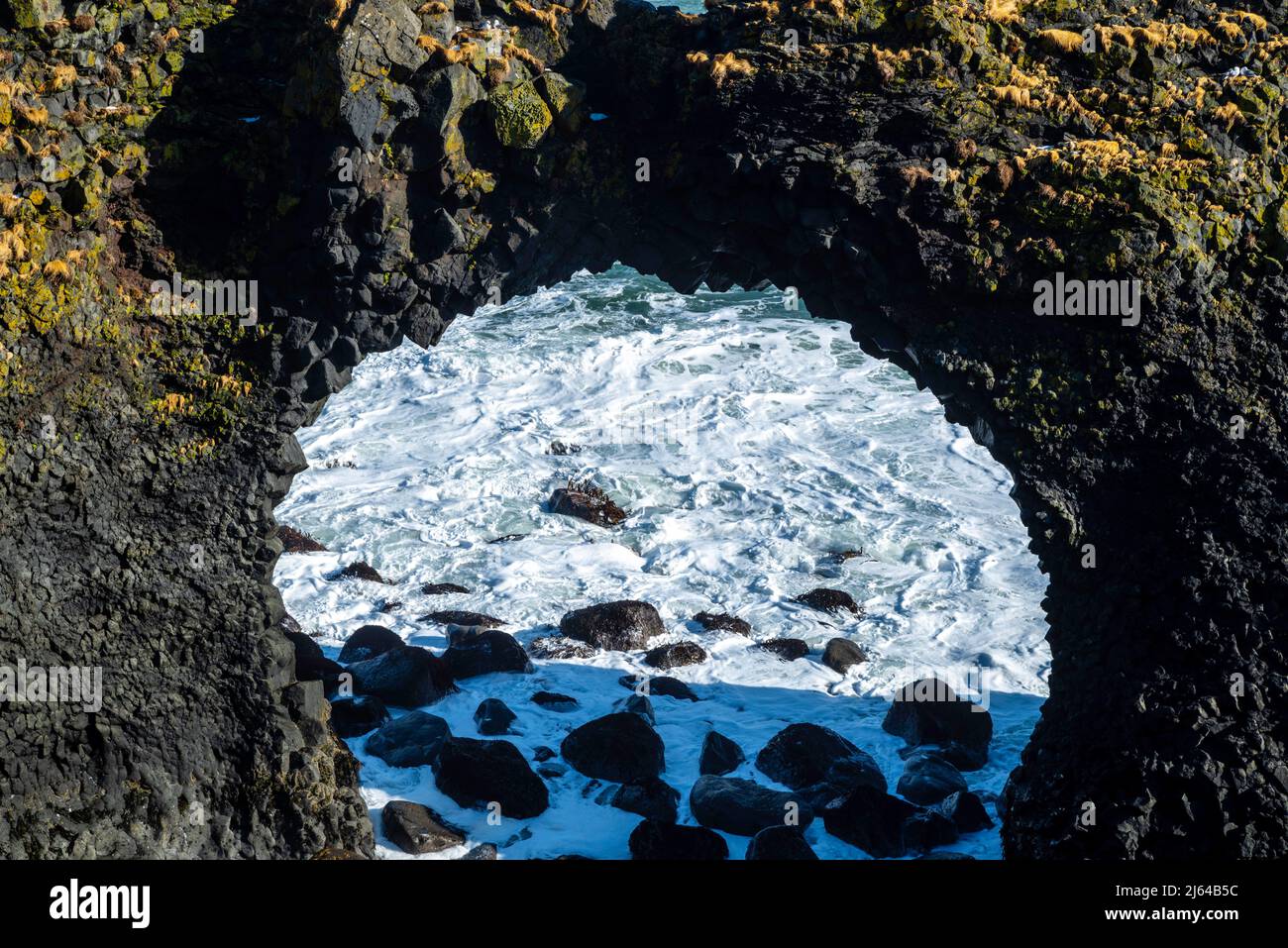 Photograph of the volcanic rock bridge at the Gatklettur Cliff walk ...