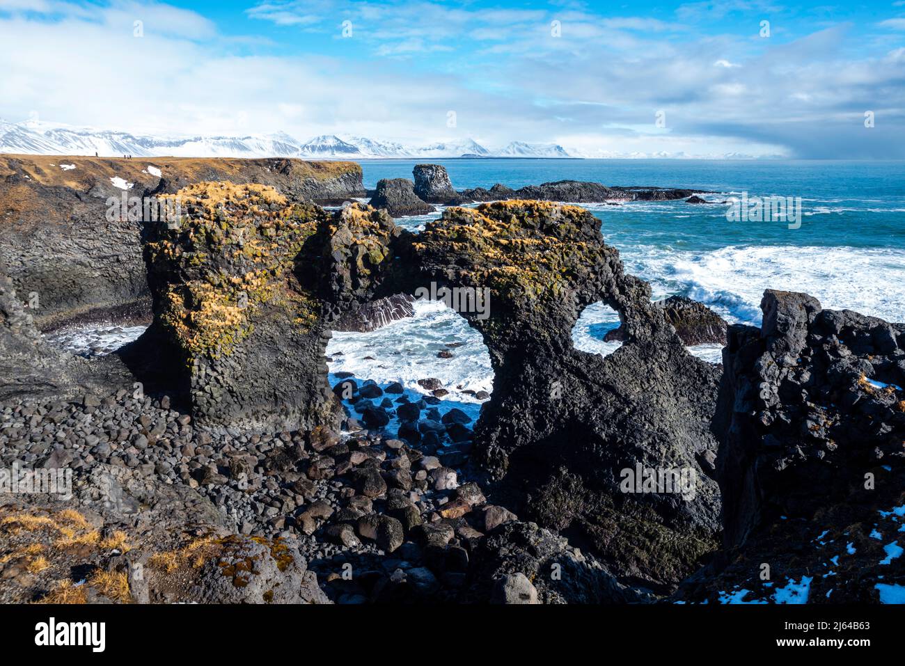 Photograph of the volcanic rock bridge at the Gatklettur Cliff walk ...
