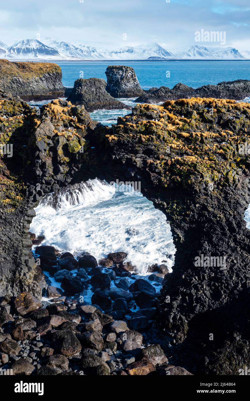 Photograph of the volcanic rock bridge at the Gatklettur Cliff walk ...
