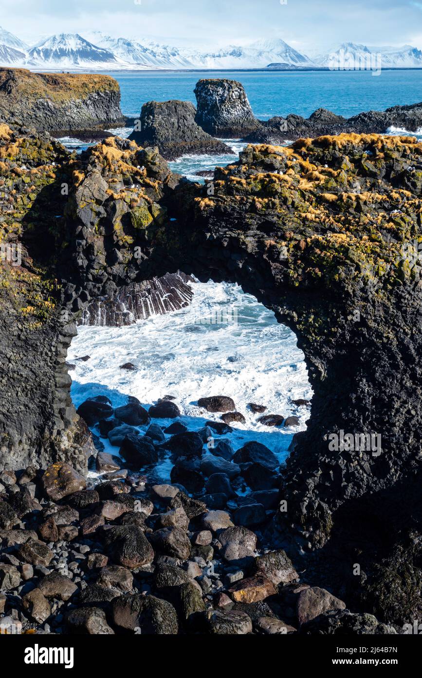Photograph of the volcanic rock bridge at the Gatklettur Cliff walk ...